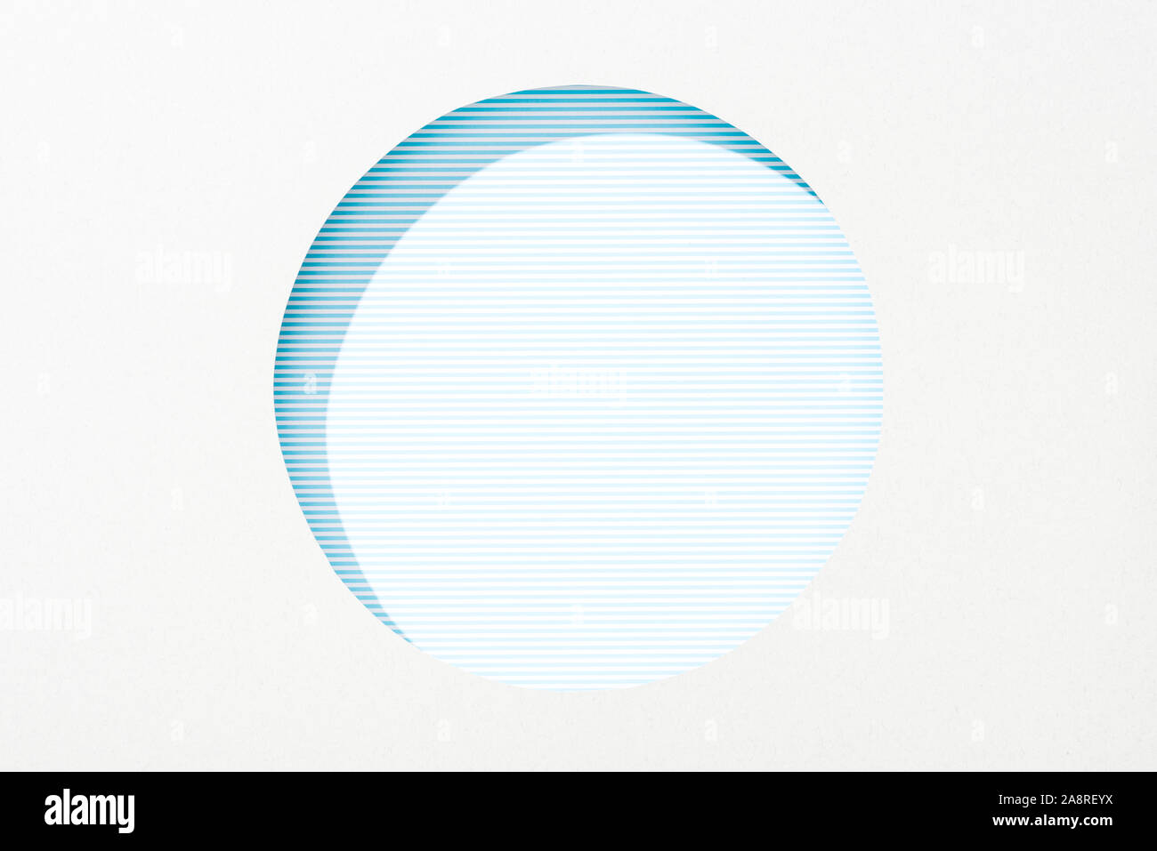 cut out round hole in white paper on striped blue background Stock ...