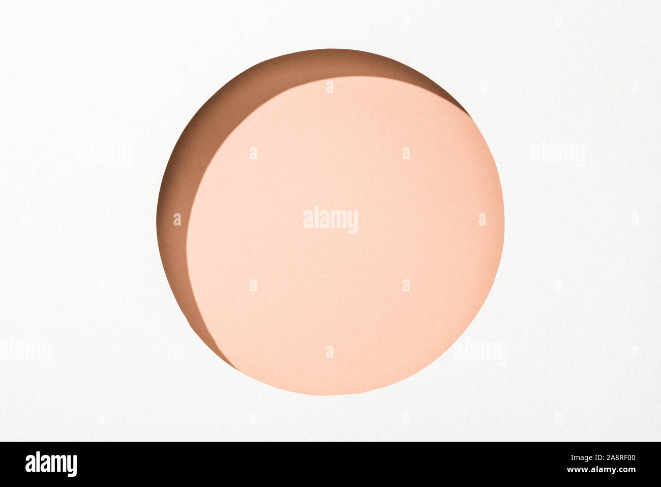 cut out round hole in white paper on beige pastel background Stock ...