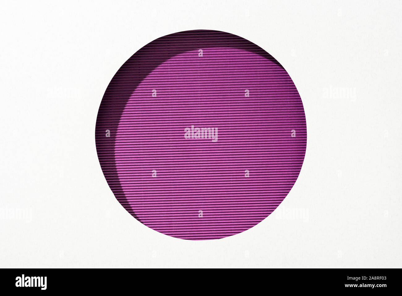 cut out round hole in white paper on striped purple background Stock ...