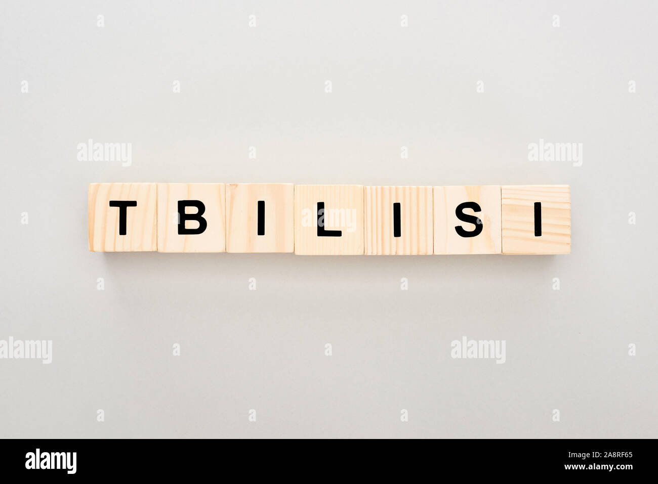 top view of wooden blocks with Tbilisi lettering on white background ...