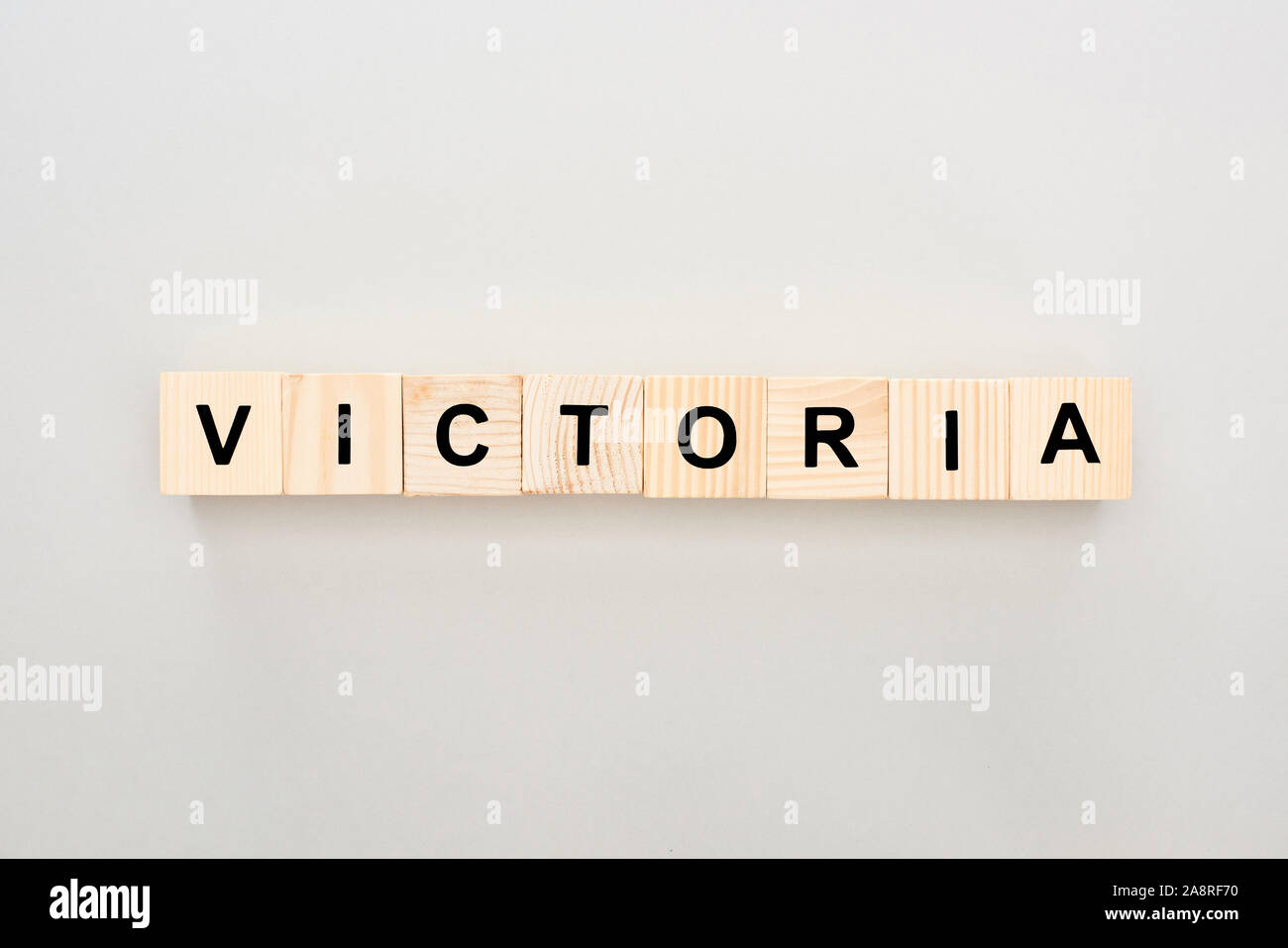 top view of wooden blocks with Victoria lettering on white background ...