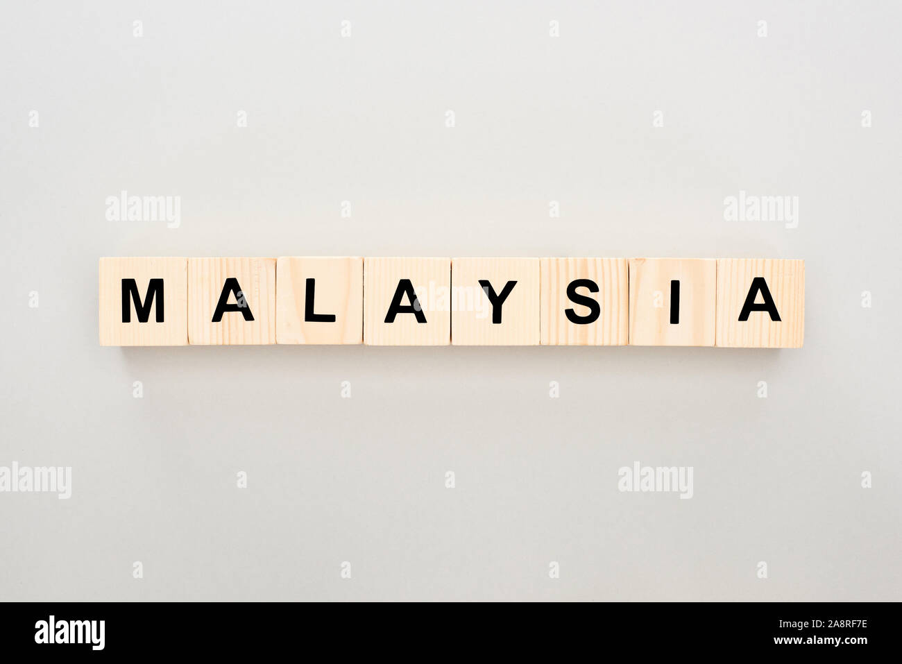 top view of wooden blocks with Malaysia lettering on white background ...