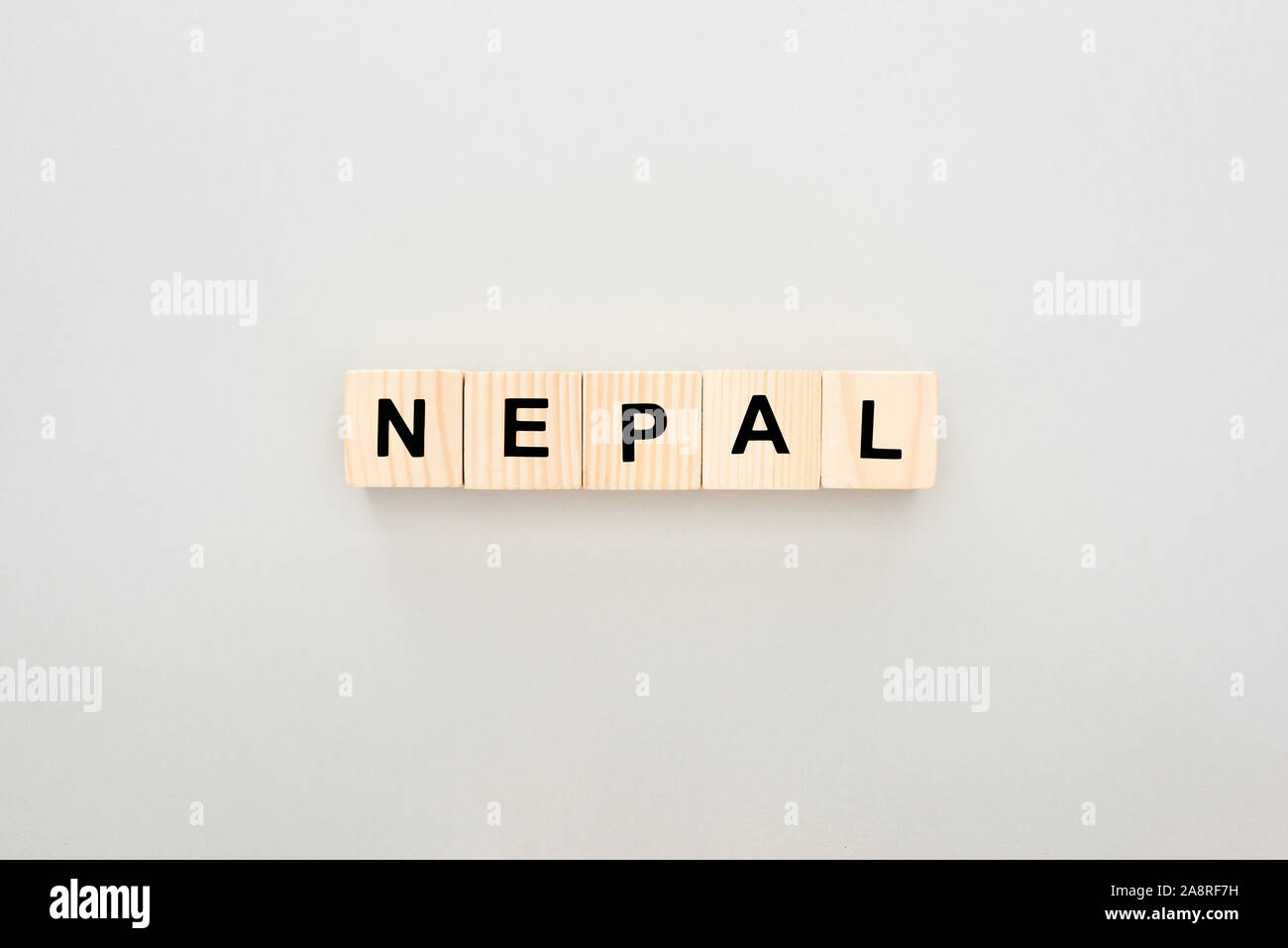 top view of wooden blocks with Nepal lettering on white background ...