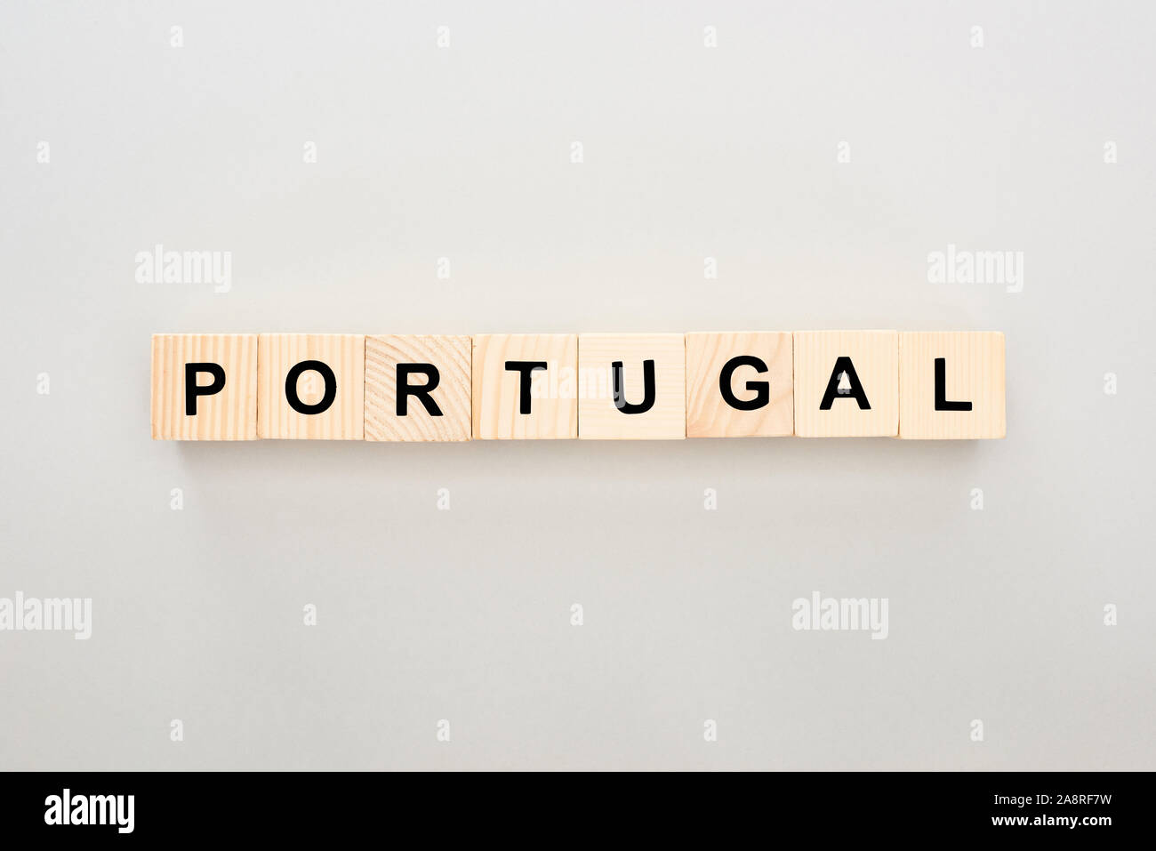 top view of wooden blocks with Portugal lettering on white background ...