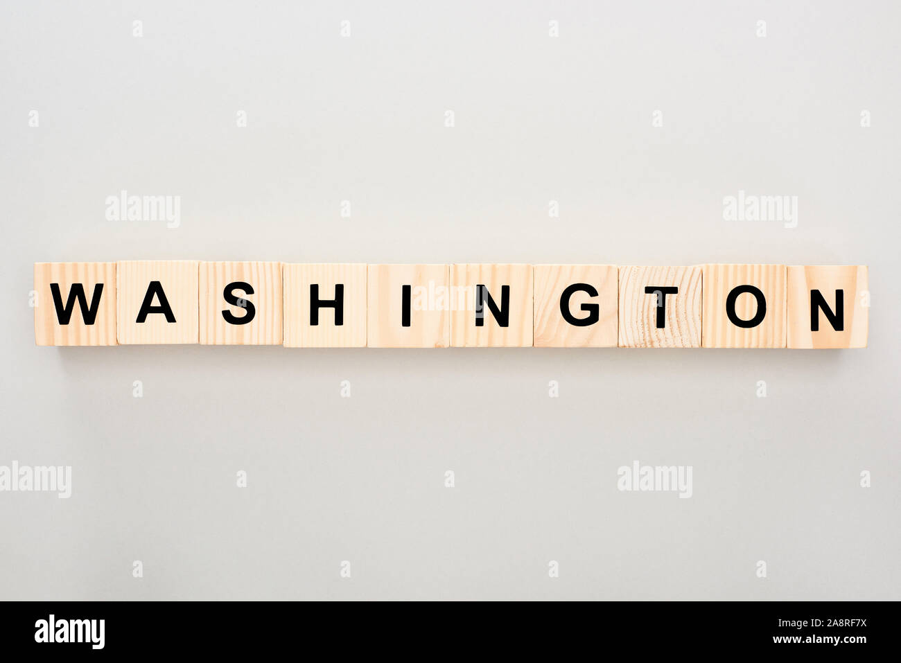 top view of wooden blocks with Washington lettering on white background ...