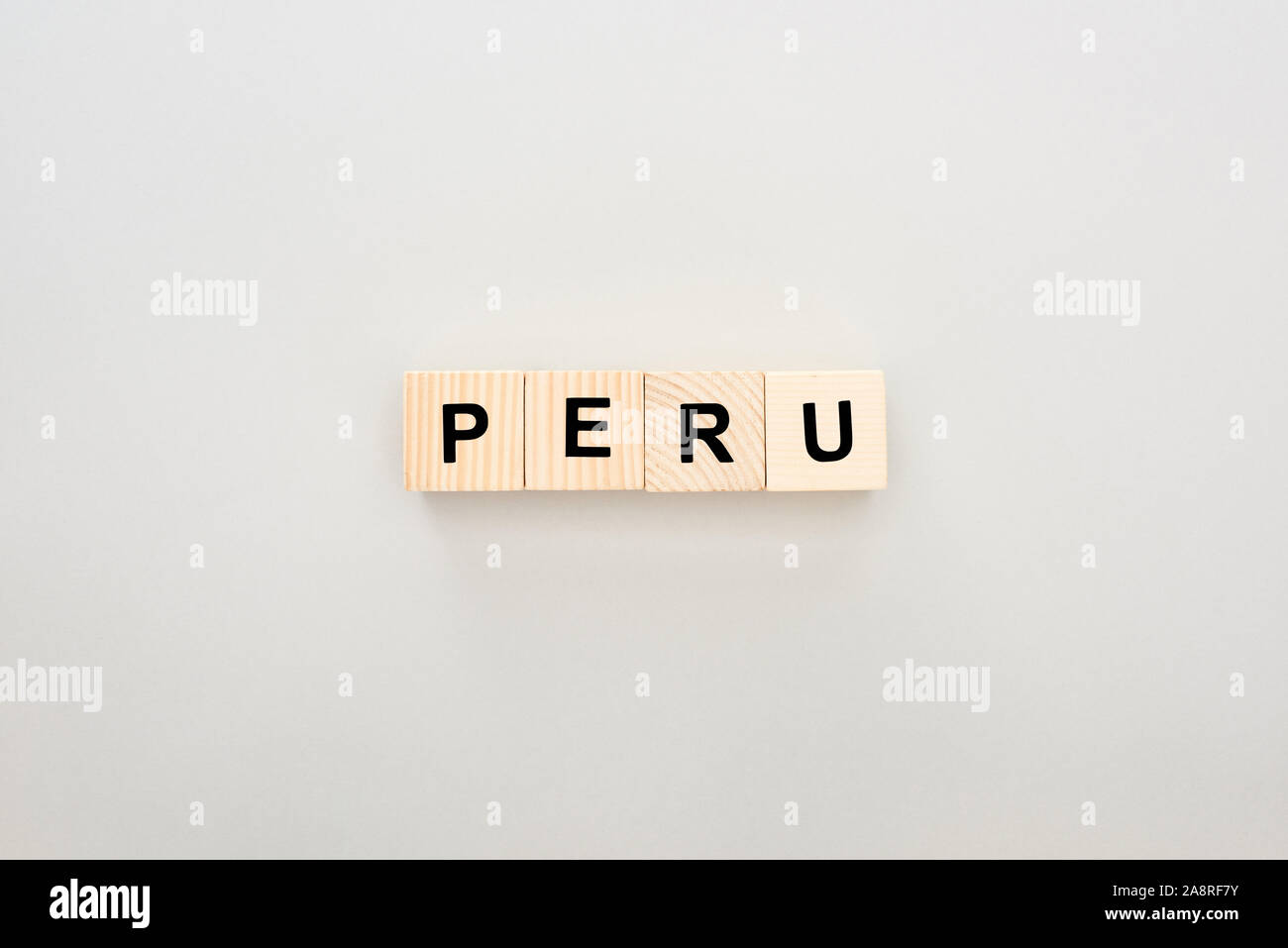 top view of wooden blocks with Peru lettering on white background Stock ...