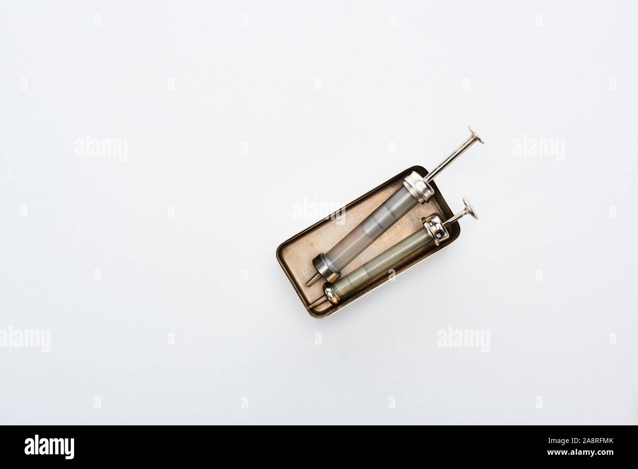 top view of aged syringes in vintage box on white background with copy ...