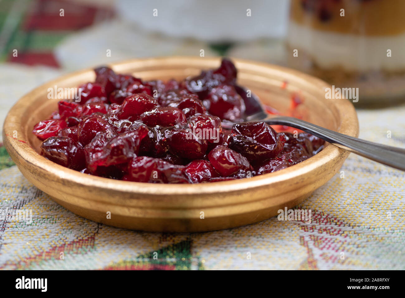 Cranberry preserve served in gold plate Stock Photo - Alamy