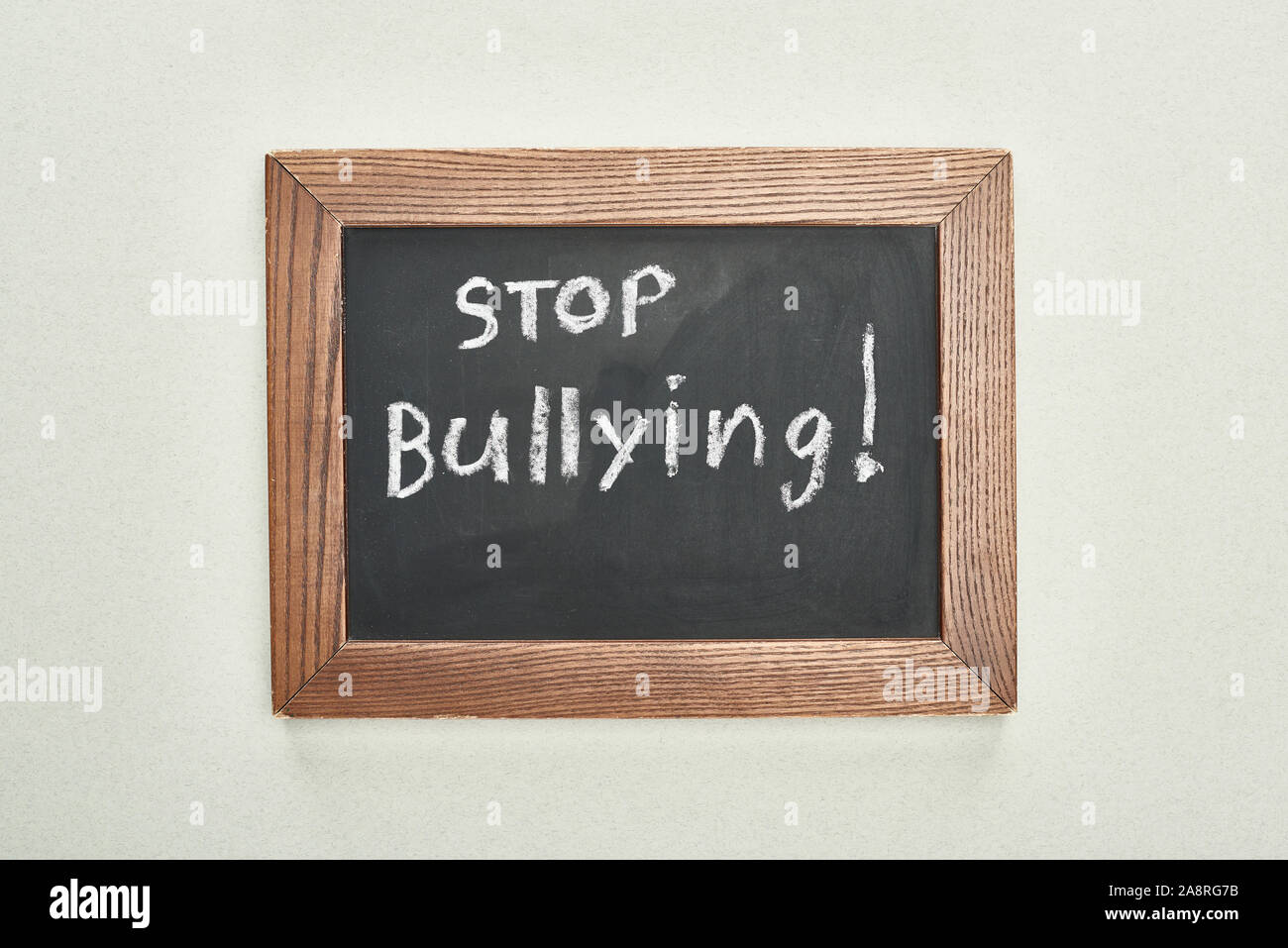 top view of chalkboard in wooden frame with stop bullying lettering on ...