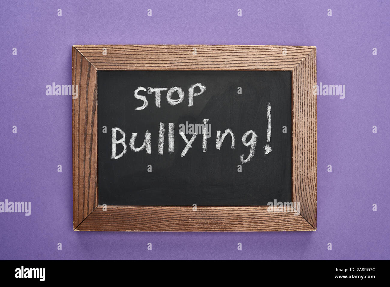 top view of chalkboard in wooden frame with stop bullying lettering on ...