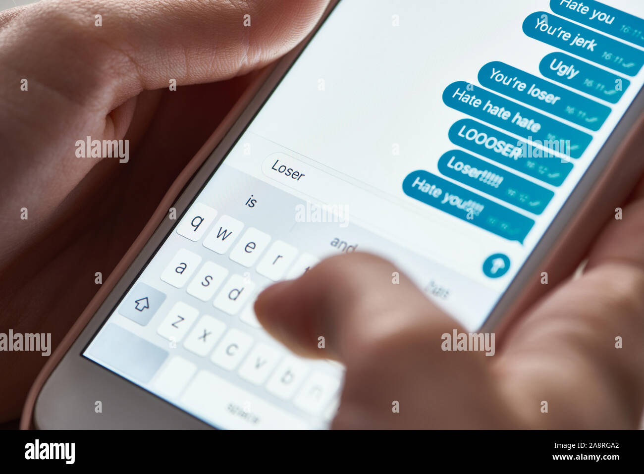 partial view of abuser sending offensive messages while using ...