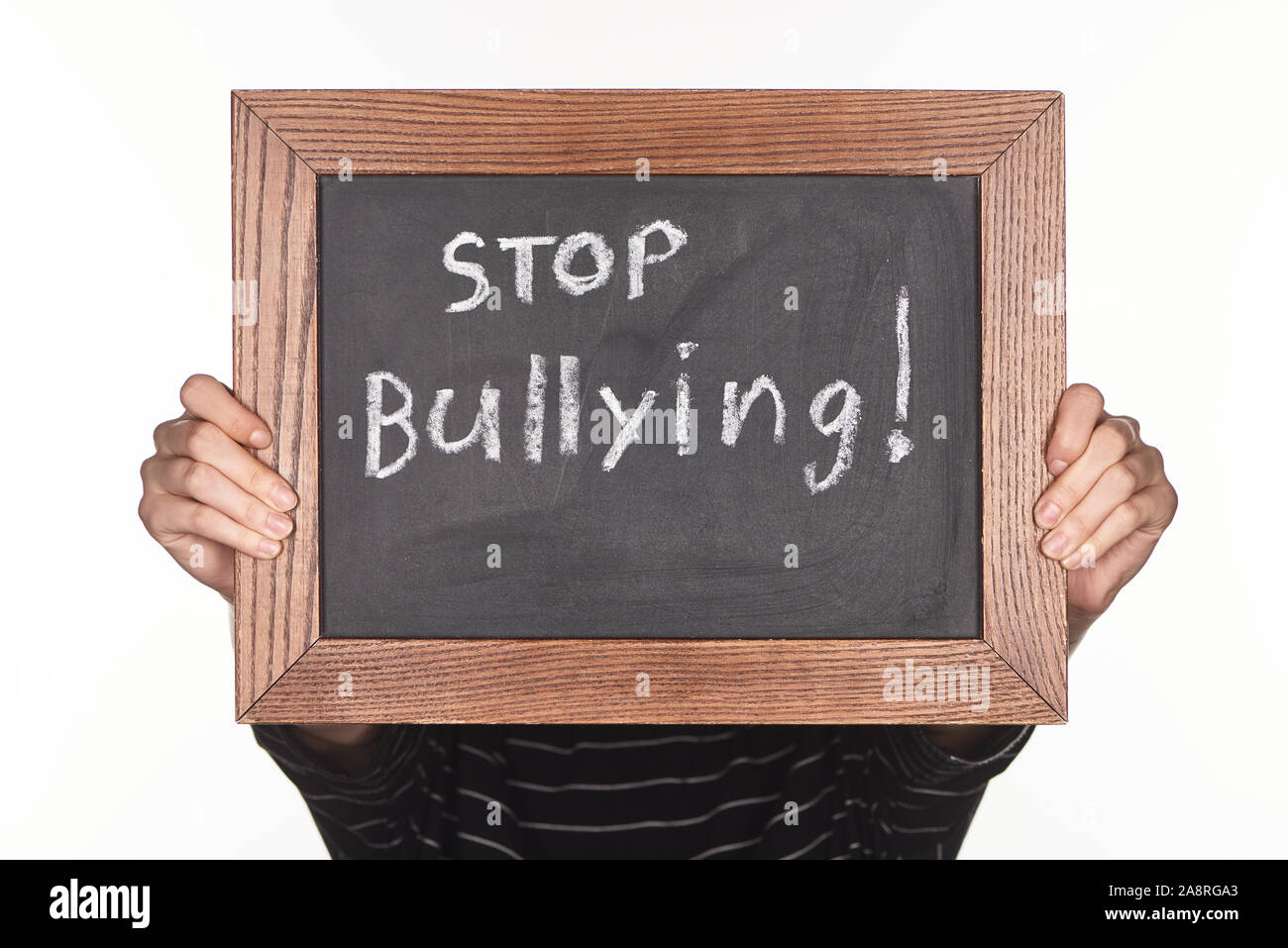girl holding chalkboard in wooden frame with stop bullying lettering ...