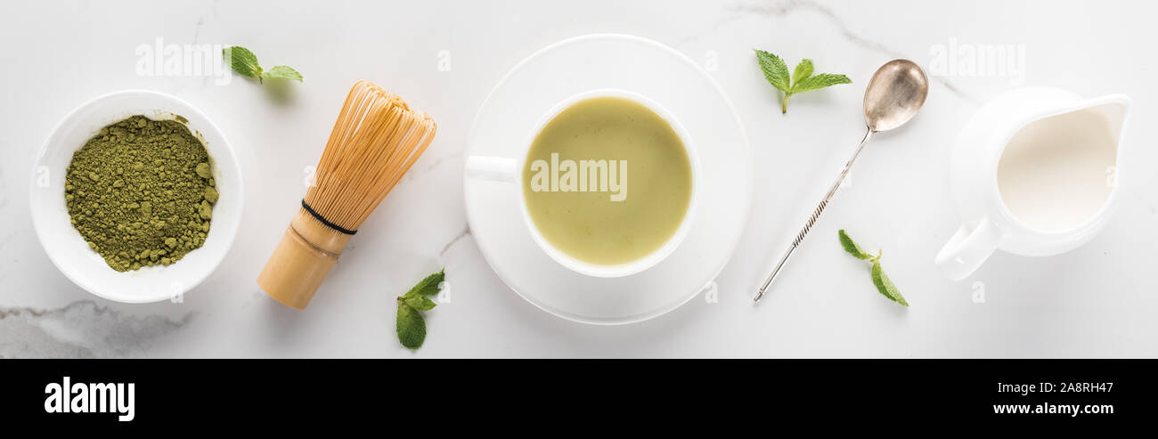 flat lay with green matcha tea and milk on white table Stock Photo - Alamy