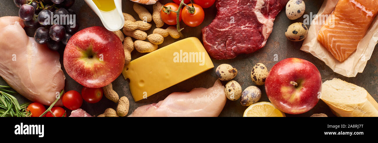 Panoramic shot of raw meat, poultry and fish with cheese, peanuts ...