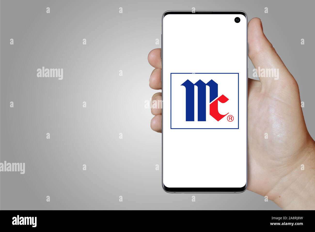 Logo of public company McCormick & Co. displayed on a smartphone. Grey ...