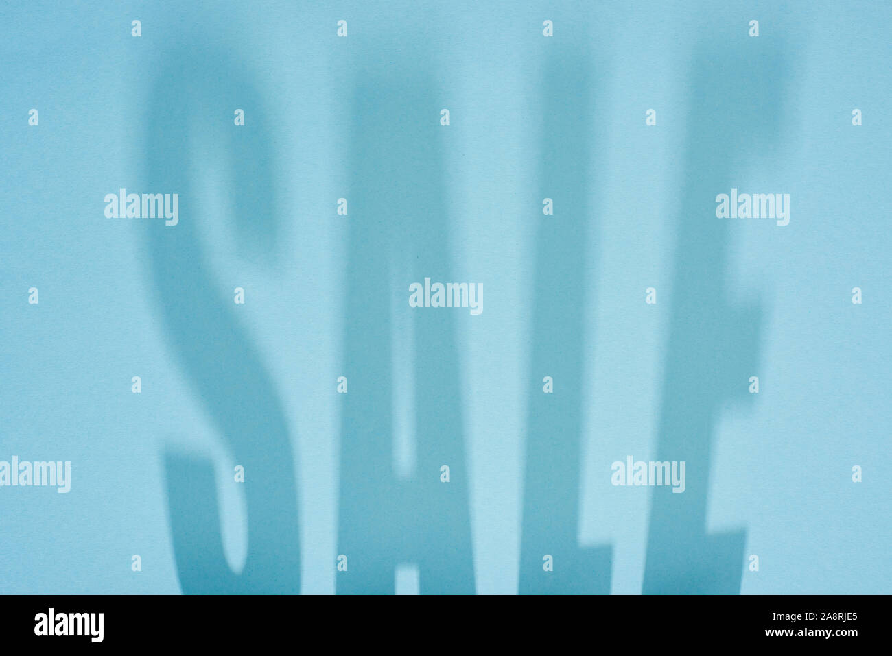shadow of sale lettering on light blue background Stock Photo - Alamy