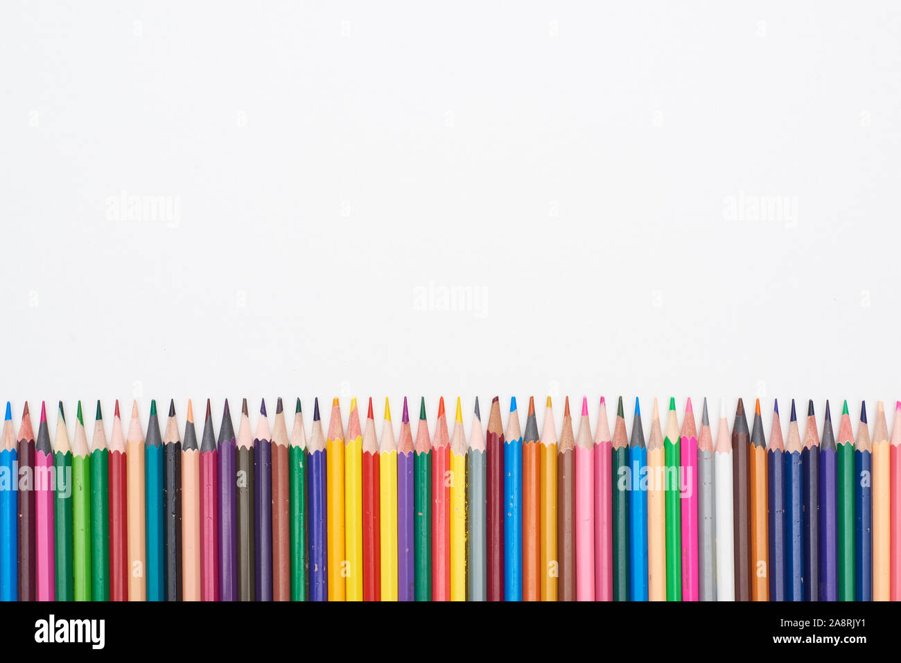 Straight line of color pencils isolated on white Stock Photo - Alamy