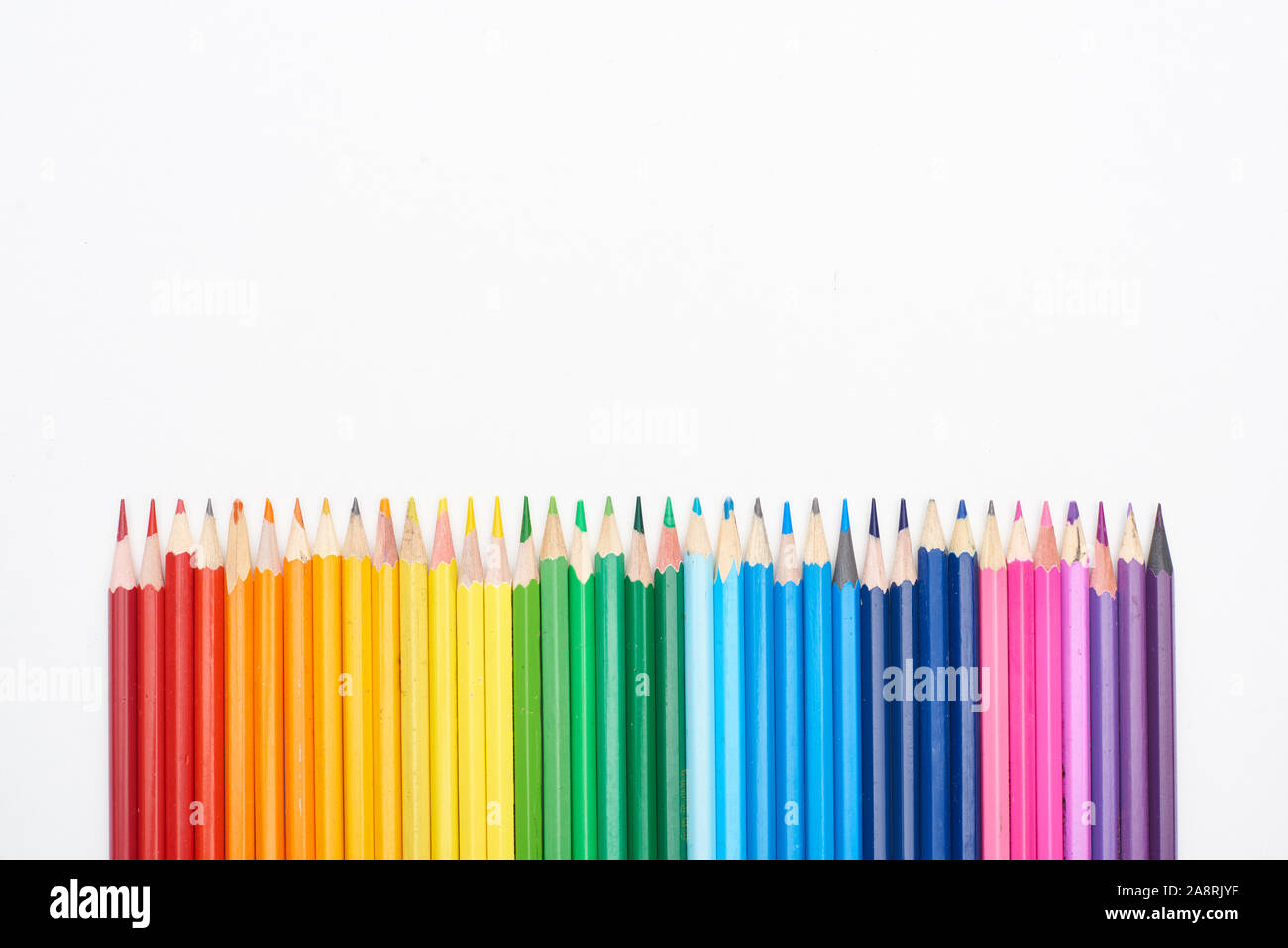 Rainbow spectrum made with straight row of color pencils isolated on ...