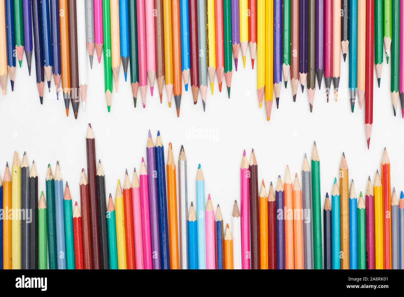 Two lines of different sizes color pencils isolated on white Stock ...