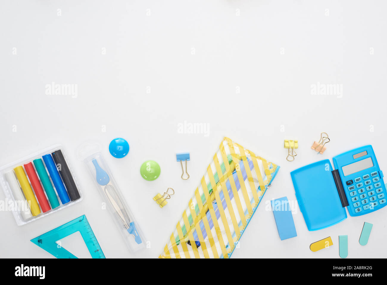 Top view of blue and yellow scattered school supplies with pencil case ...