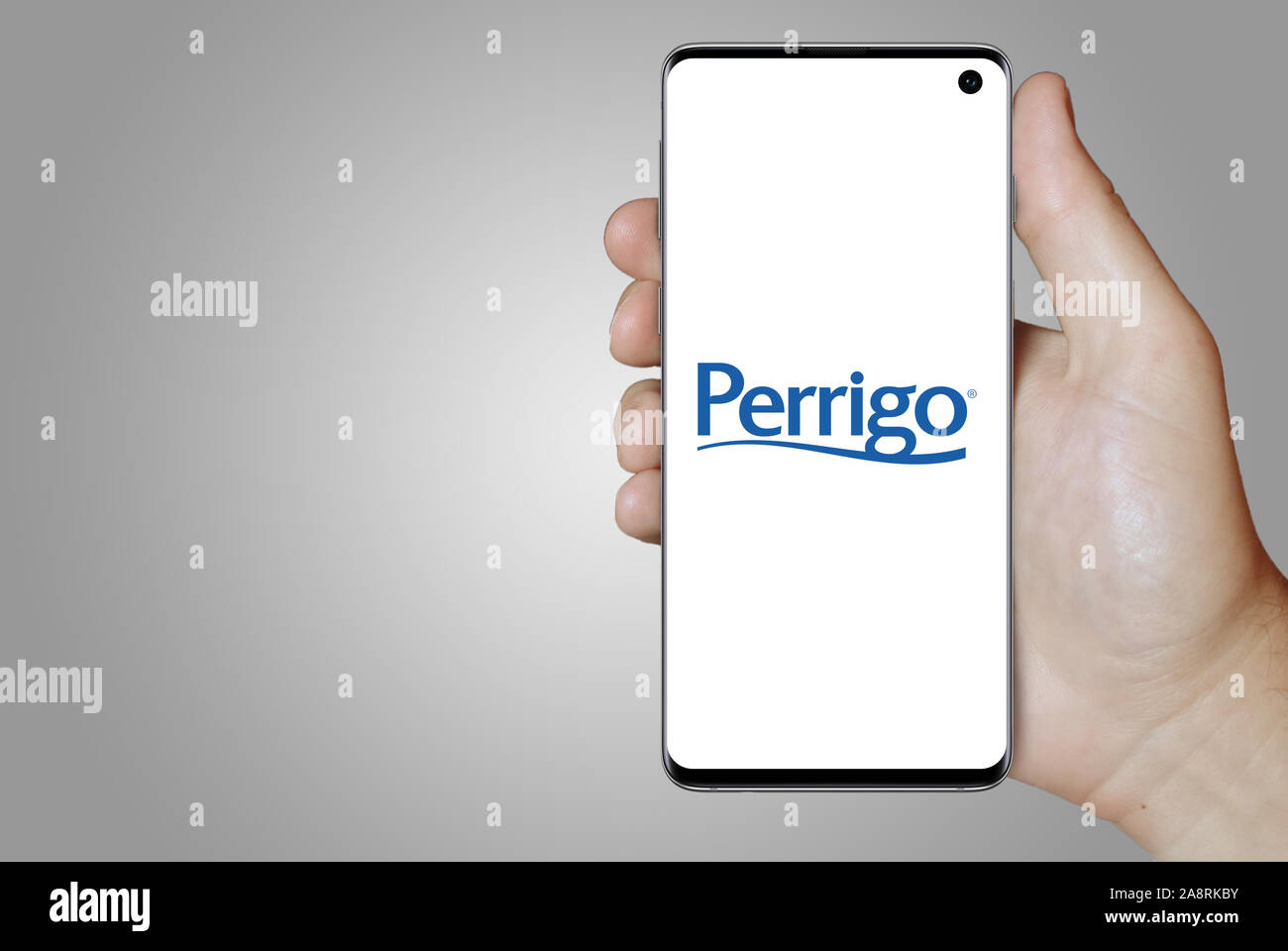 Logo of public company Perrigo displayed on a smartphone. Grey ...