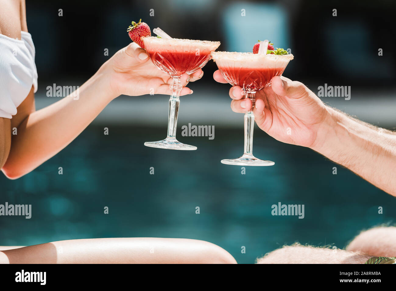 Two people clinking cocktail glasses hi-res stock photography and ...