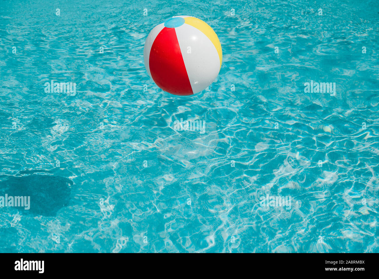 colorful inflatable ball in clean blue water in swimming pool Stock ...