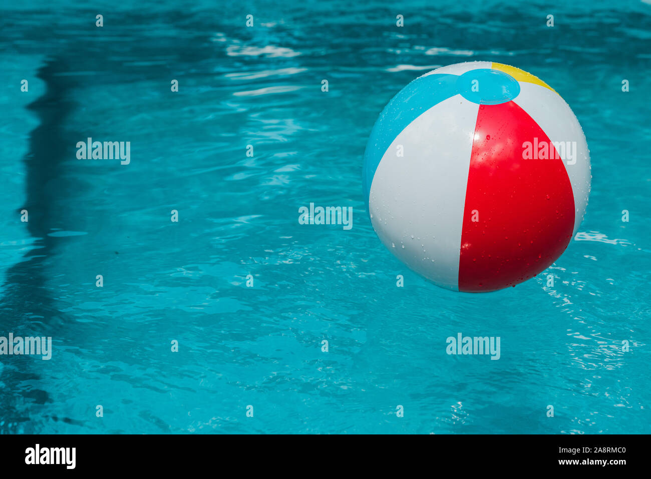 colorful inflatable ball in blue water in swimming pool Stock Photo - Alamy