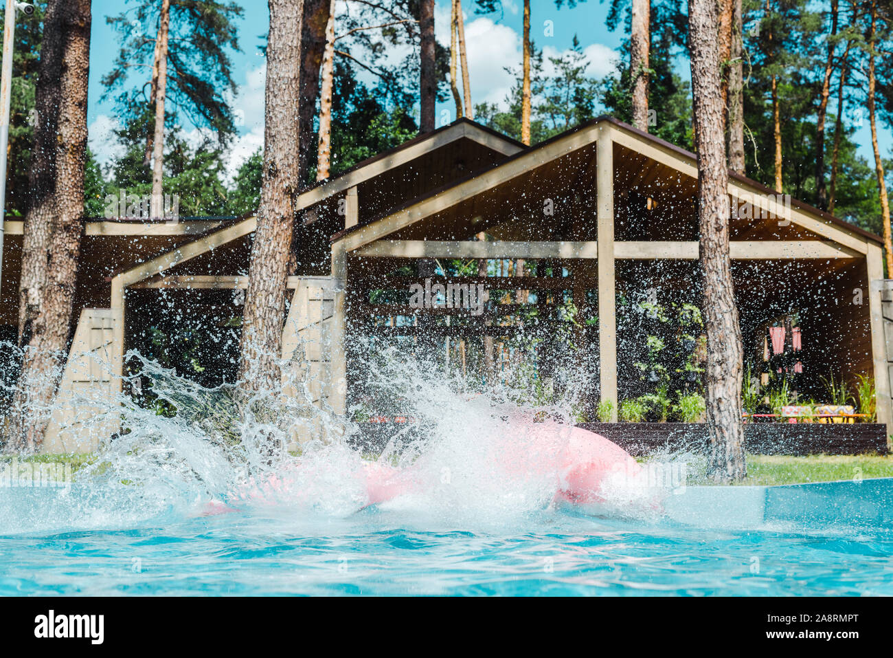 splash near inflatable rings in swimming pool with clean blue water ...