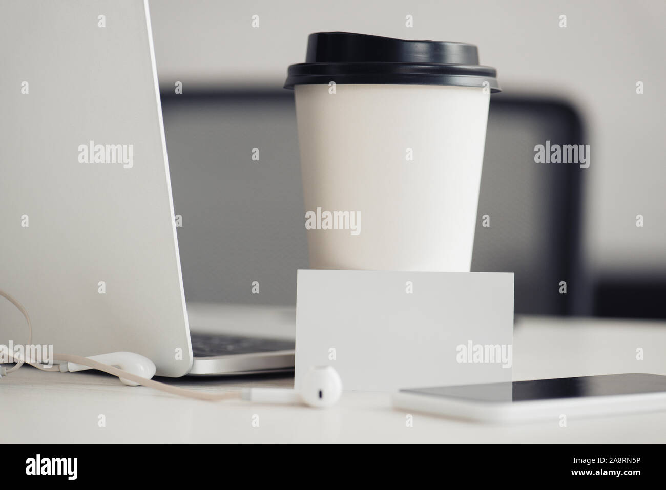 empty business cards near disposable cup, laptop and smartphone on ...