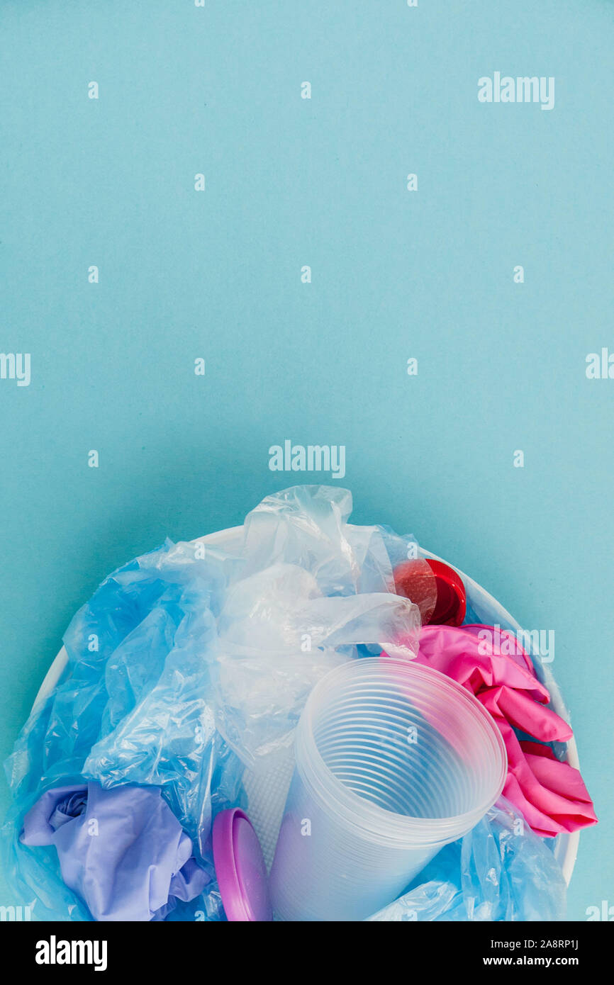 Top view of various kinds of disposable plastic waste on blue ...