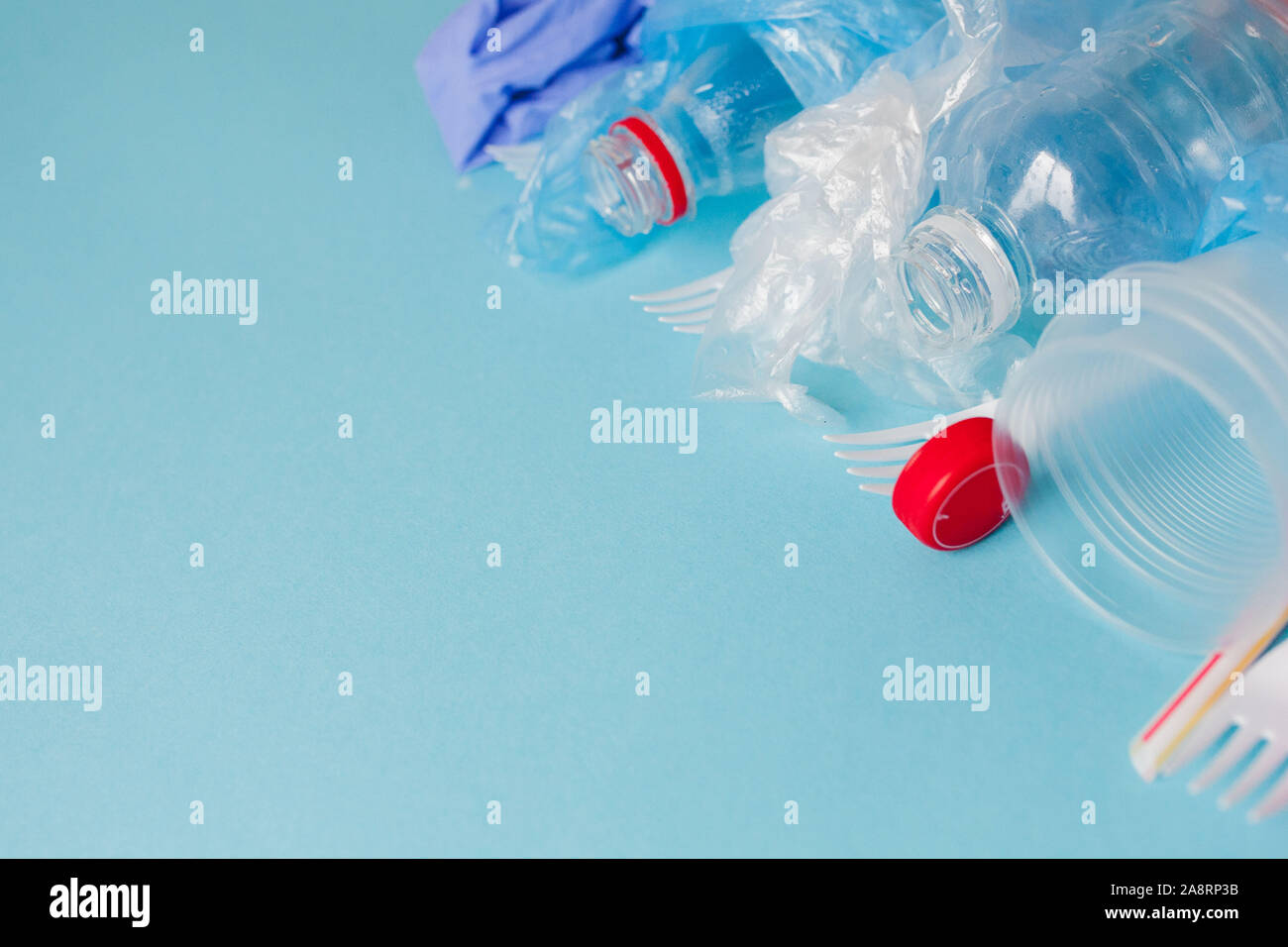 Top view of various kinds of disposable plastic waste on blue ...