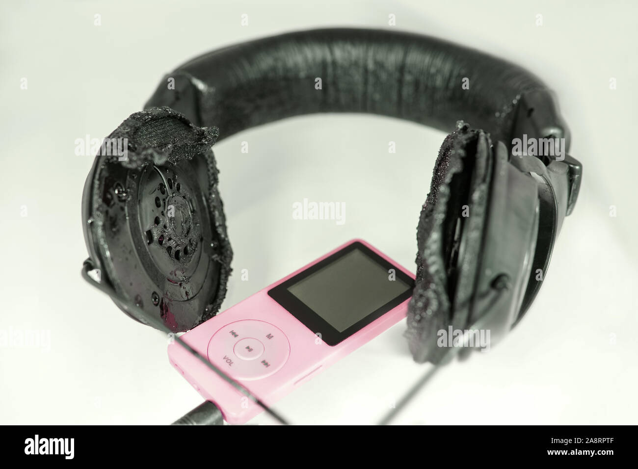 On a clear surface, a burned headphone attached to a personal music ...