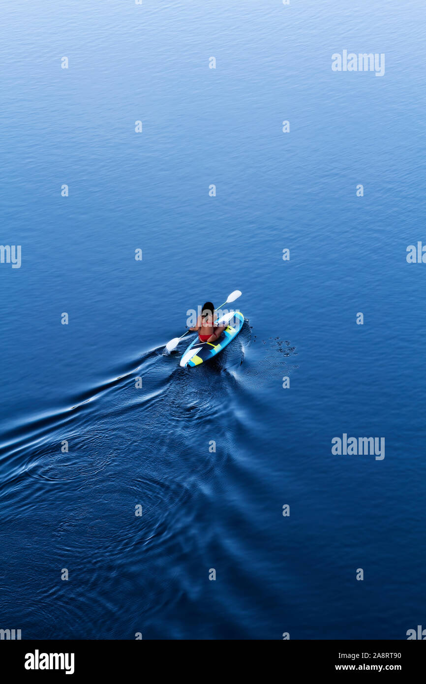 Woman In Red Bikini Sitting On Paddle Board With Kayak Oar Paddling On ...