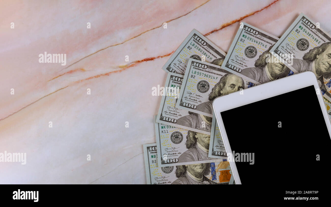 Digital tablet with screen in over cash money american dollars in ...