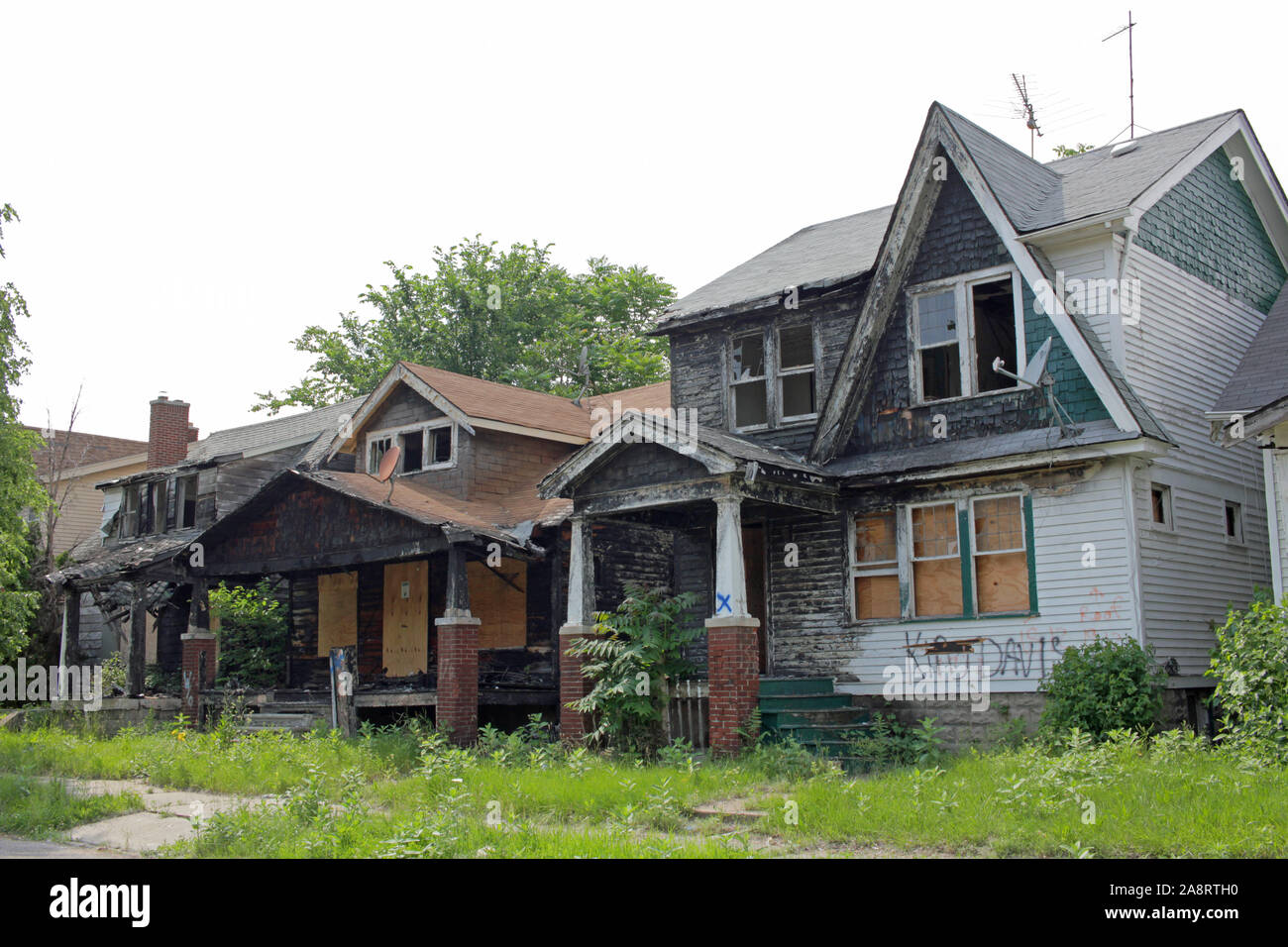 Ruined and fire damaged houses with gang graffiti, Detroit, Michigan ...
