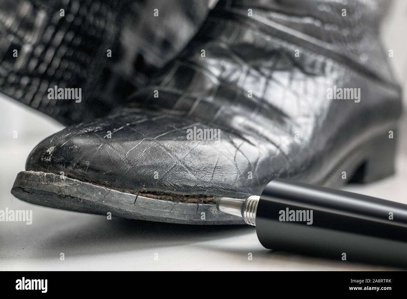 Old women's boots with side damage made of genuine leather imitating a ...