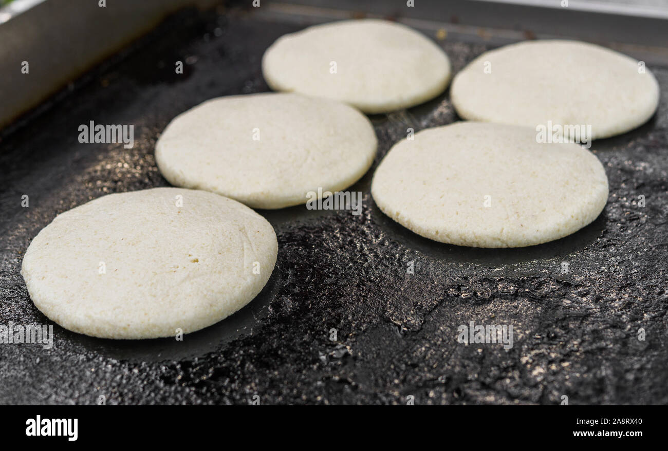 Uncooked arepas, traditional Venezuelan corn patties, at a street food ...
