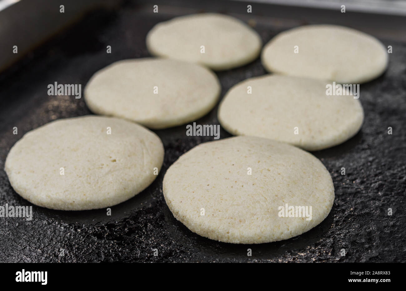 Uncooked arepas, traditional Venezuelan corn patties, at a street food ...