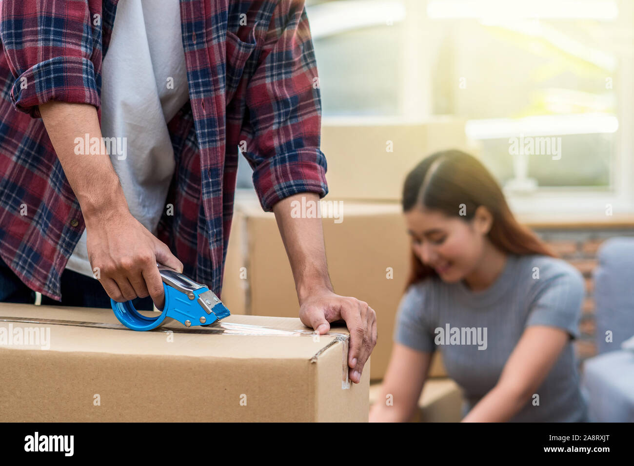 Asian man packing boxes hi-res stock photography and images - Alamy