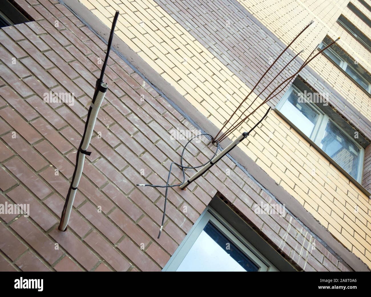 Pipes for installing air conditioning coming out of the wall of a new ...