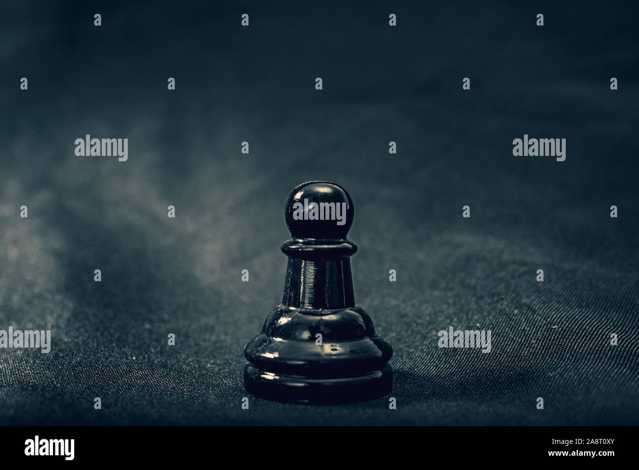 black glass Pawn chess piece on dramatic background Stock Photo - Alamy