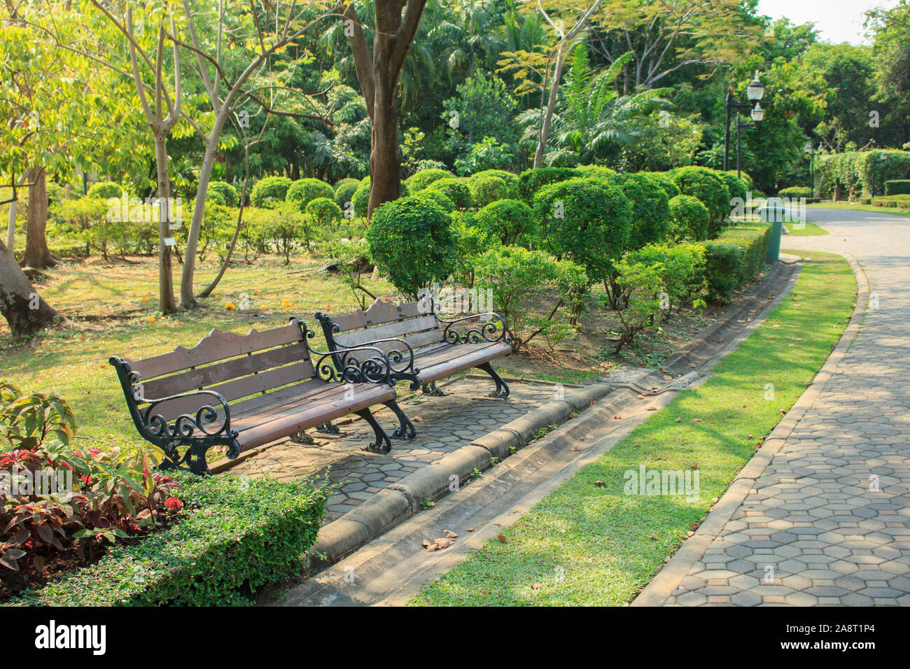 Bench in beautiful city park for relax on vacation Stock Photo - Alamy