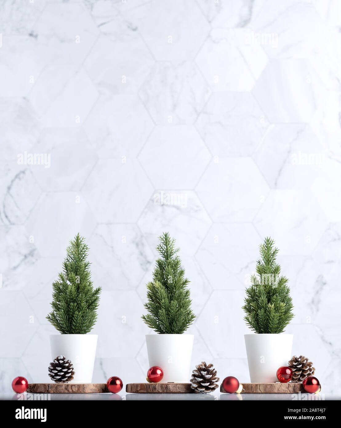 Three christmas tree with pine cone and decor xmas ball on white table ...