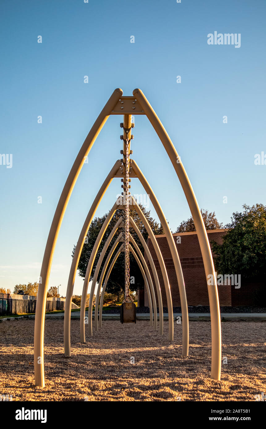 Empty chain swings on playground in the neighborhood park before sunset ...
