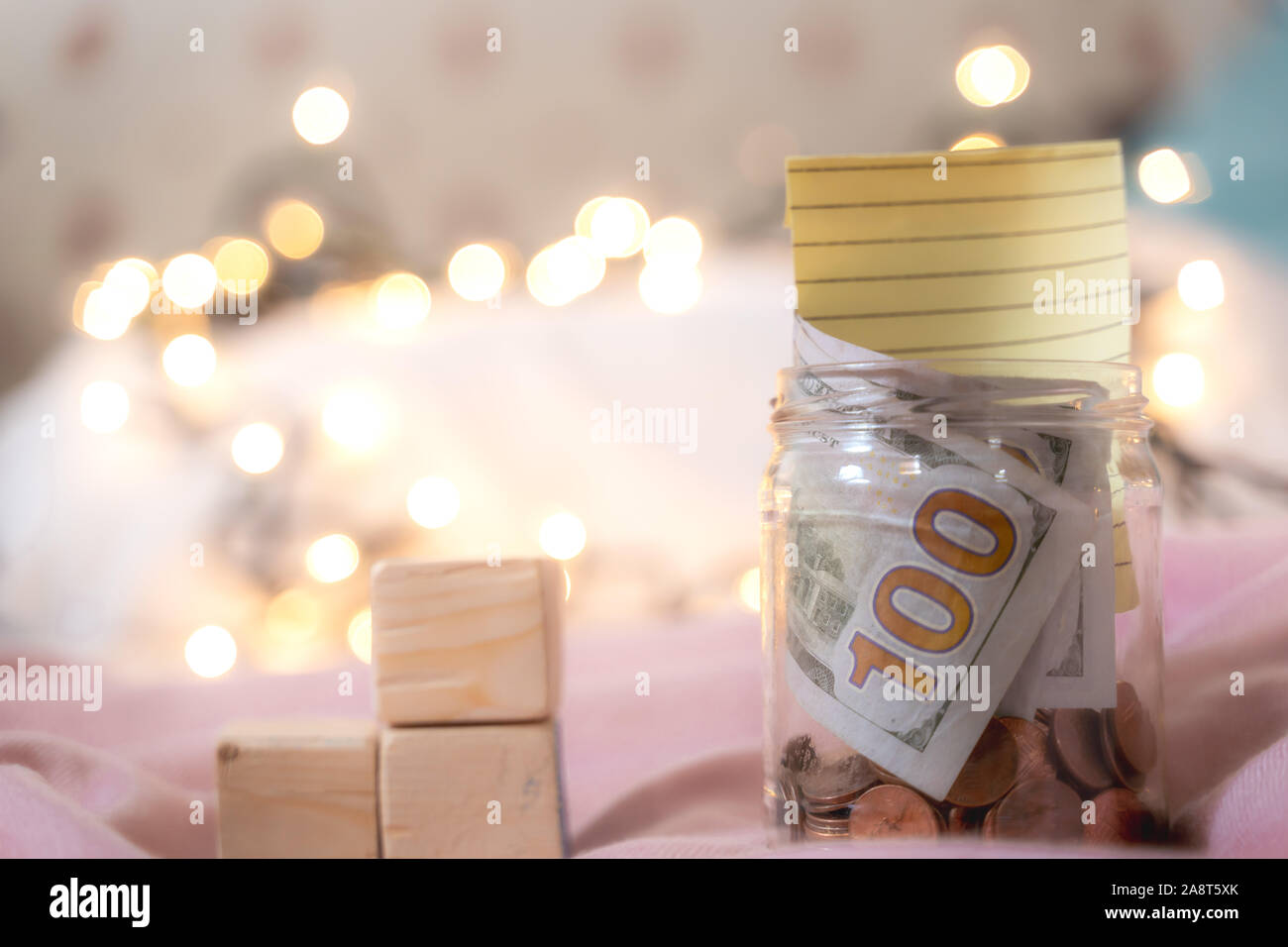 The money collected in the jar contains coins and 100 dollar bills. A ...