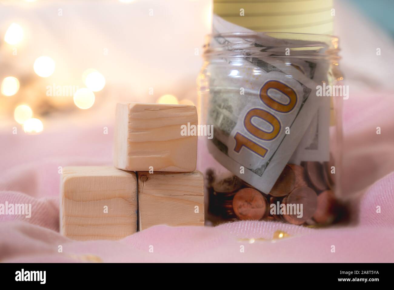The money collected in the jar contains coins and 100 dollar bills. A ...