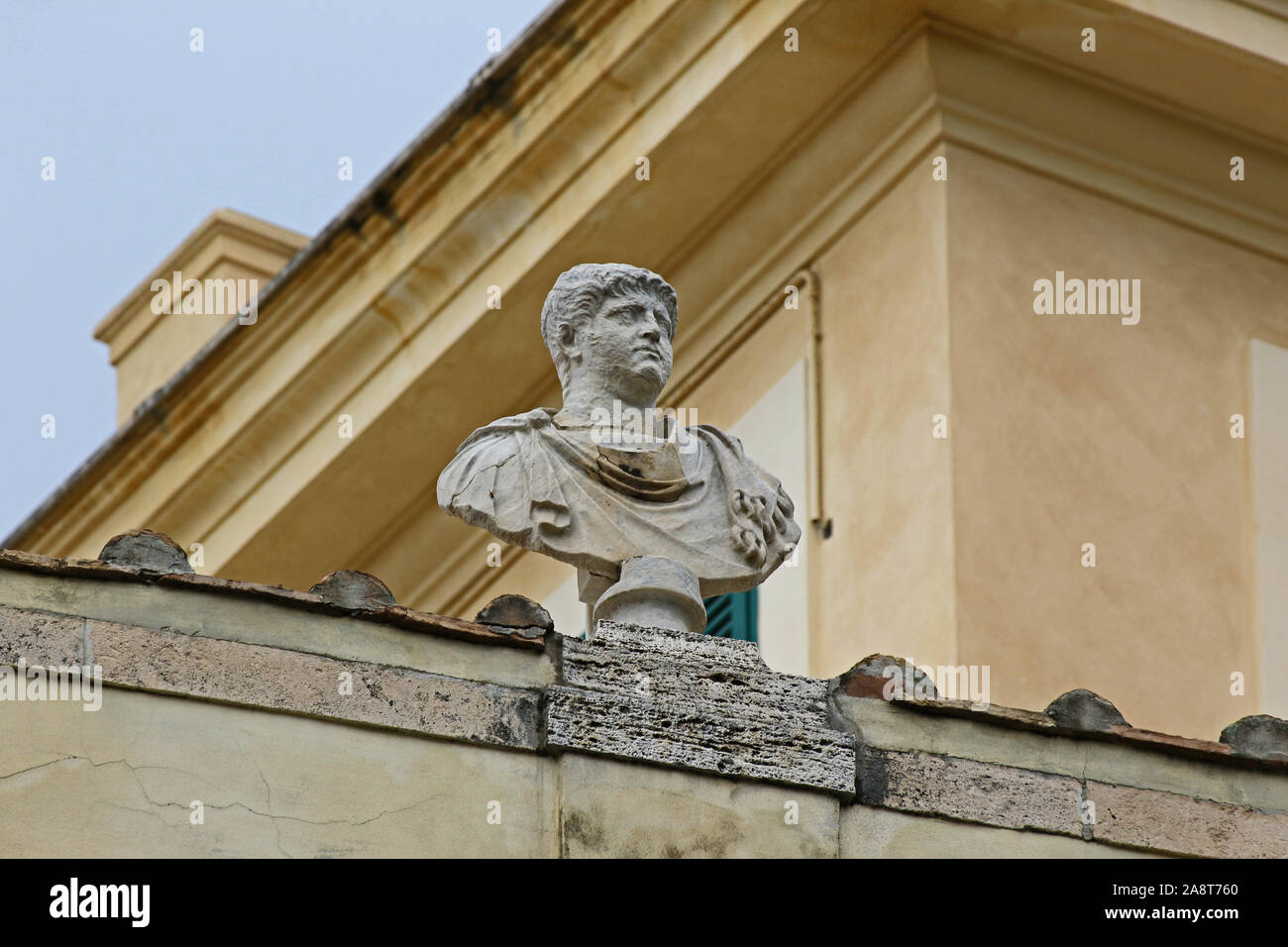 ancient bust of a Roman Emperor on a building in the streets of Rome ...