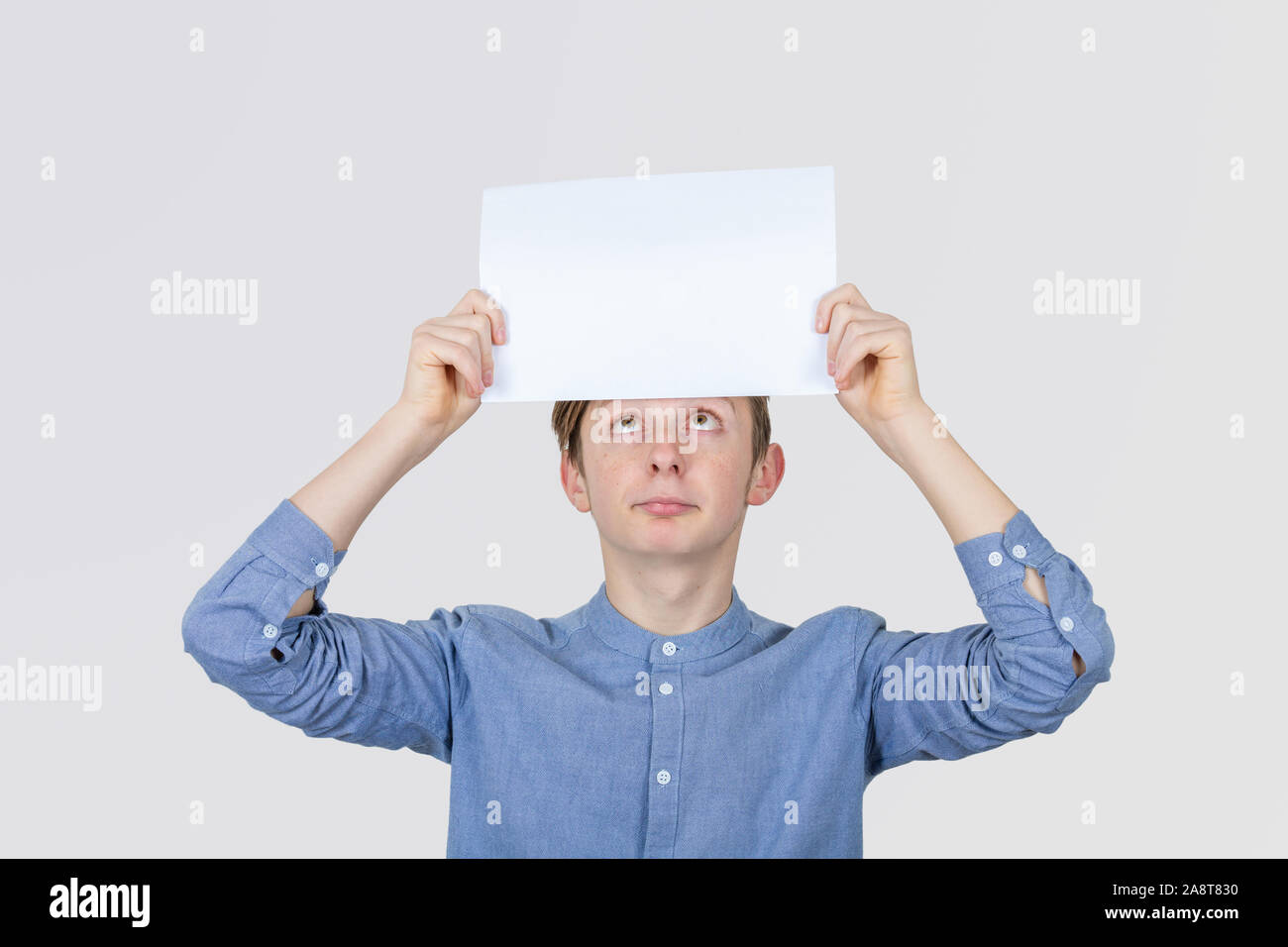 Portrait of confused, thinking young boy seeks a solution looking up ...