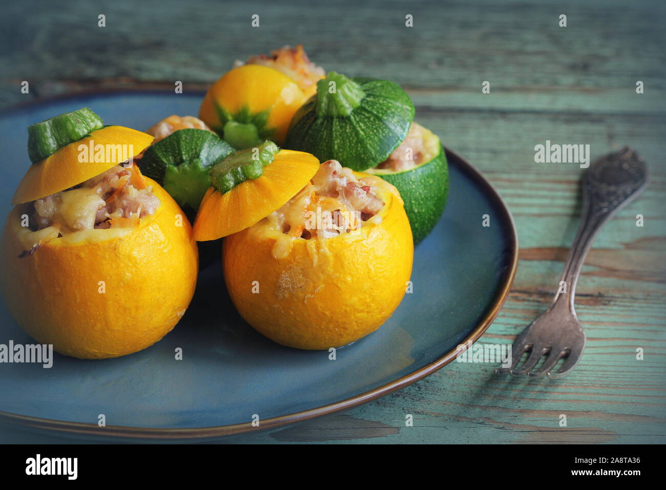 Roasted round zucchini stuffed with minced meat, vegetables, and cheese ...